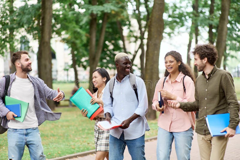 Group of Happy Students Walking through the Park. Stock Image - Image ...