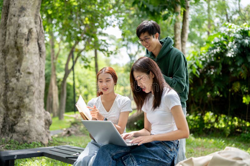 A Group of Happy Young Asian College Students is Discussing Their ...