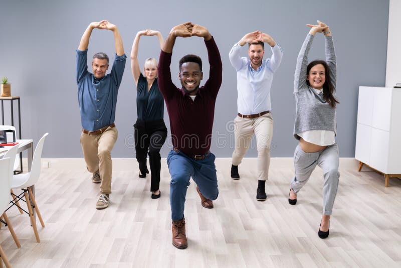 Businesspeople Doing Stretching Exercise at Workplace Stock Photo ...