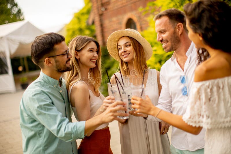 Group of Happy Young People Cheering with Fresh Lemonade in the Garden ...