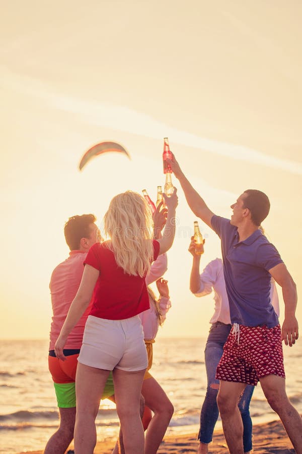 Group of Happy Young People Dancing at the Beach on Beautiful Summer ...