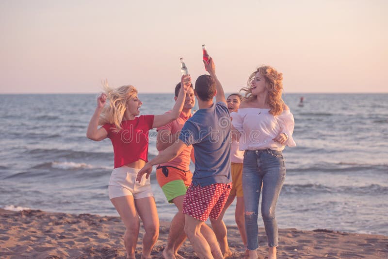 Group of Happy Young People Dancing at the Beach on Beautiful Summer ...