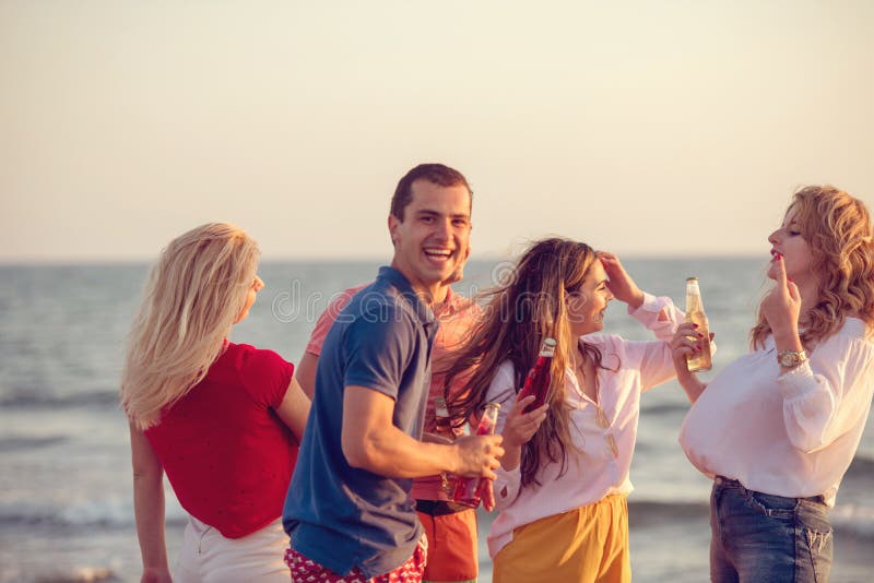 Group of Happy Young People Dancing at the Beach on Beautiful Summer ...