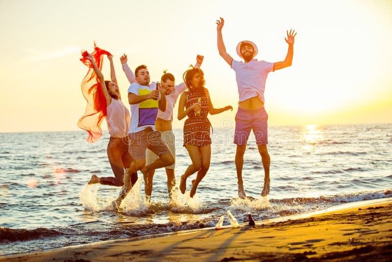 Group of Happy Young People Dancing at the Beach on Beautiful Summer ...
