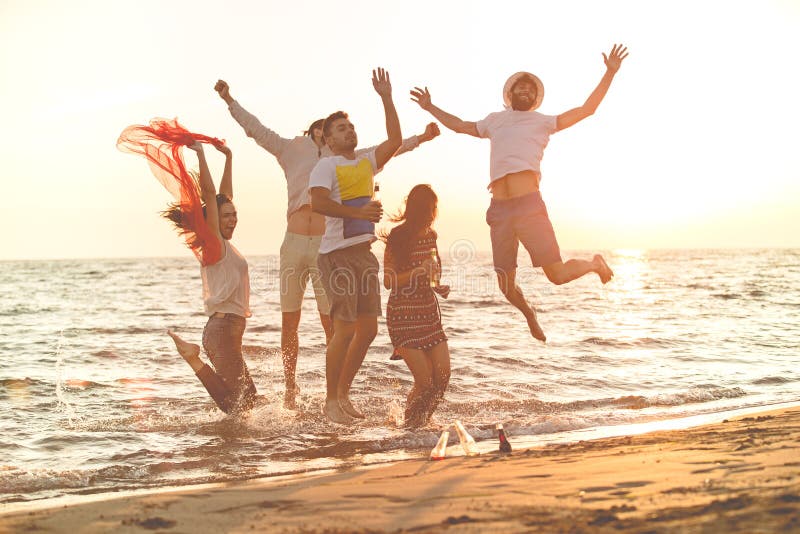Group of Happy Young People Dancing at the Beach on Beautiful Summer ...