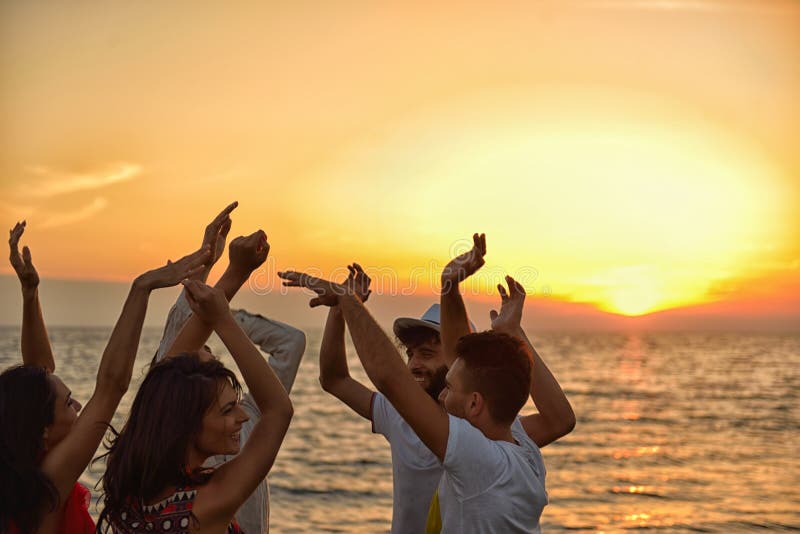 Group of Happy Young People Dancing at the Beach on Beautiful Summer ...