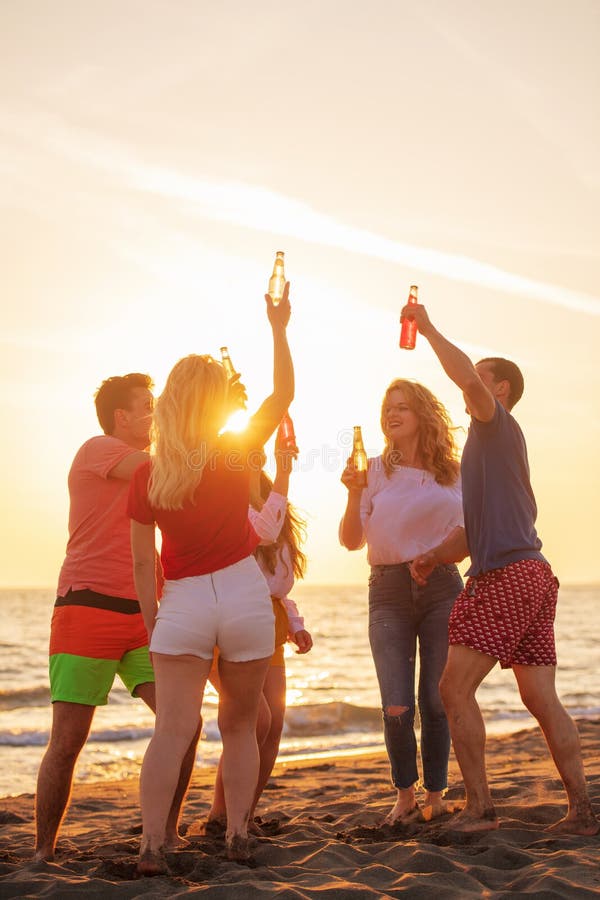 Group of Happy Young People Dancing at the Beach on Beautiful Summer ...