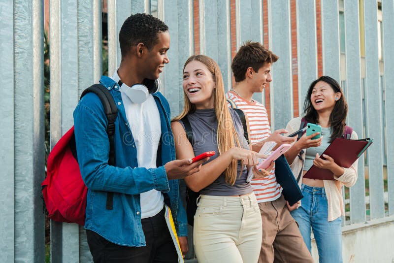 Group of Happy Young Students Socializing on University Campus ...