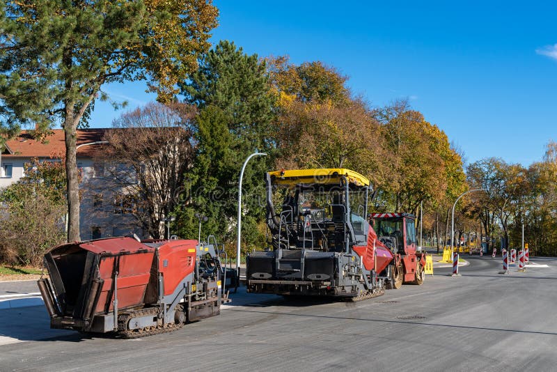 A Group of Heavy Asphalt Pavers on a Newly Made Road Stock Photo ...