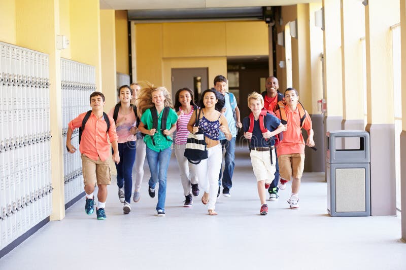 Group of High School Students Running Along Corridor Stock Photo ...