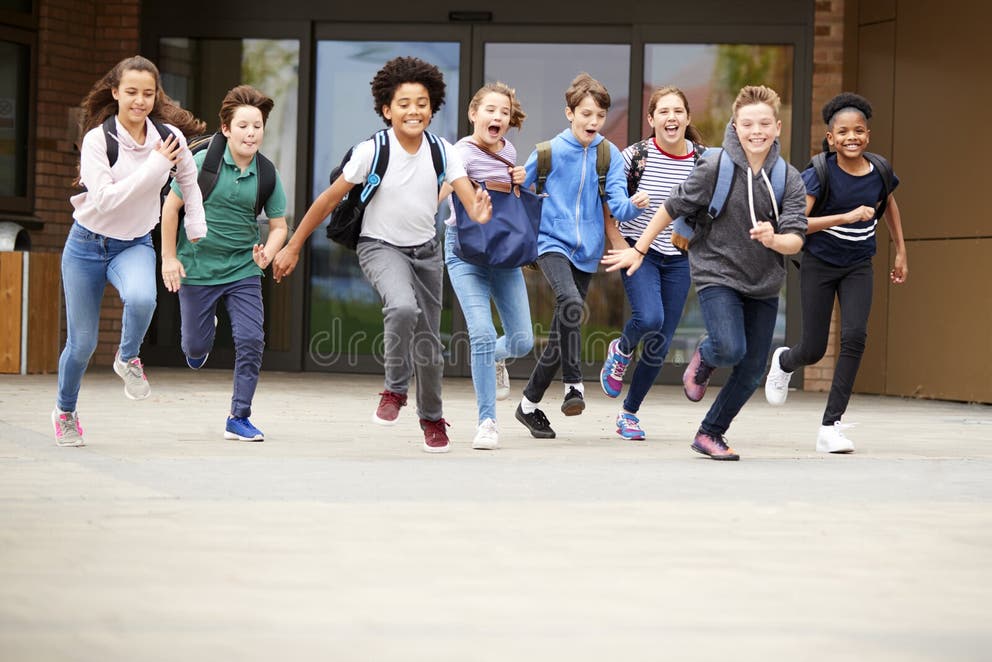 Group of High School Students Running Out of School Buildings Towards ...