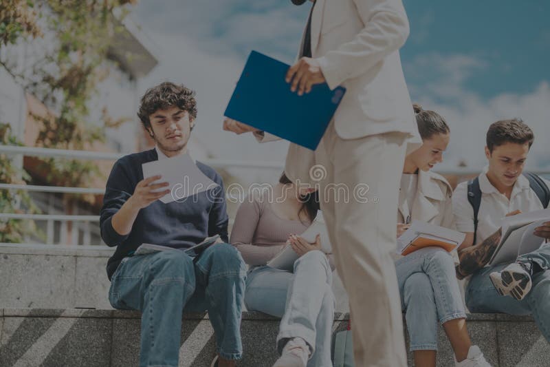High School Students Collaborating Outdoors with Teacher Assistance ...