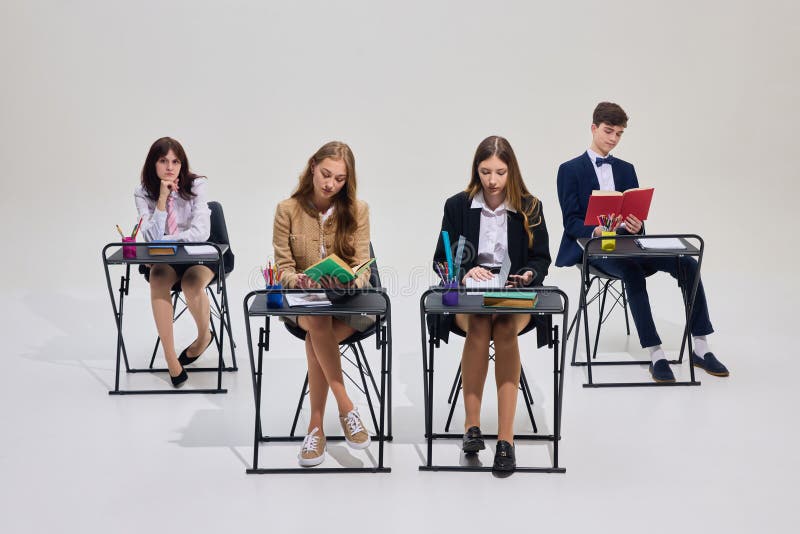 Group of High School Students Seating at Desks Reading and Writing ...