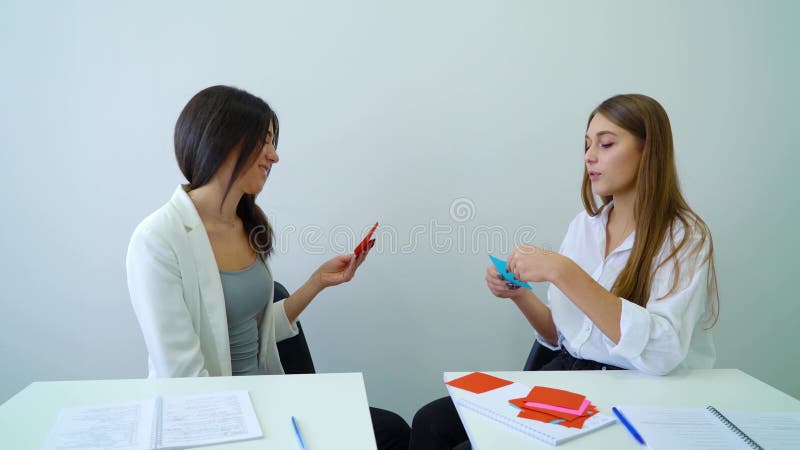 Two Female High School Students Sitting in Classroom and Having ...