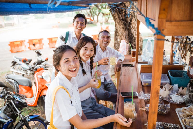 Group of High School Students in Uniform Drinking Ice Stock Photo ...