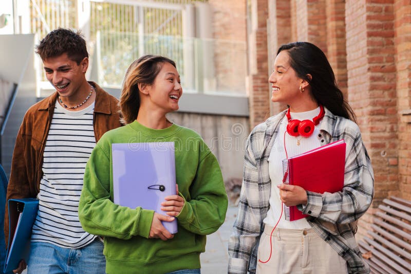 Group of Highschool Classmates Going To Class Carrying Their Folders ...