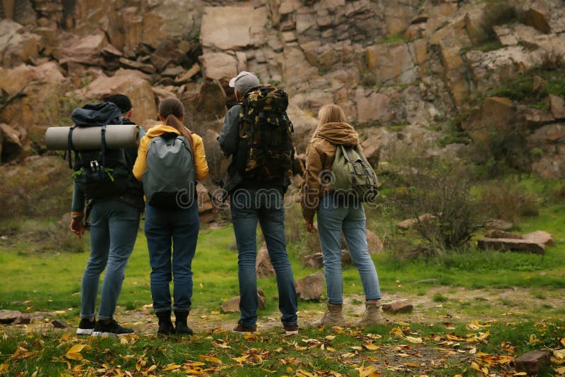Group of Hikers with Backpacks in Mountains, Back View Stock Photo ...