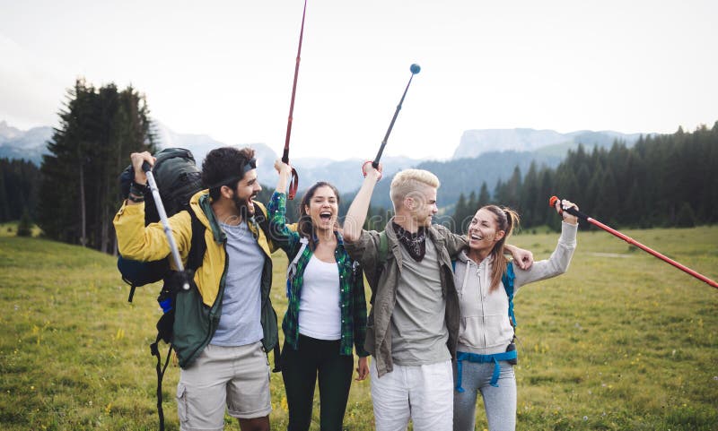 Group of Hikers with Backpacks and Sticks Walking on Mountain. Friends ...