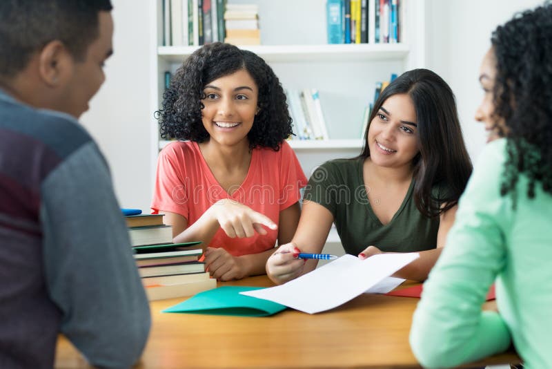 Group of Hispanic Male and Female Students Learning Together Stock ...