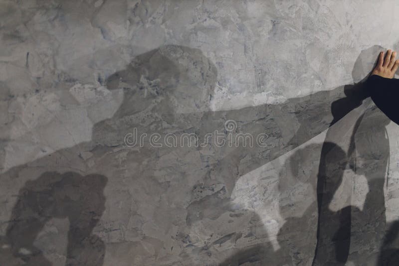 Group of Human Shadows on the Stone Wall at Sunset Time. Stock Image ...