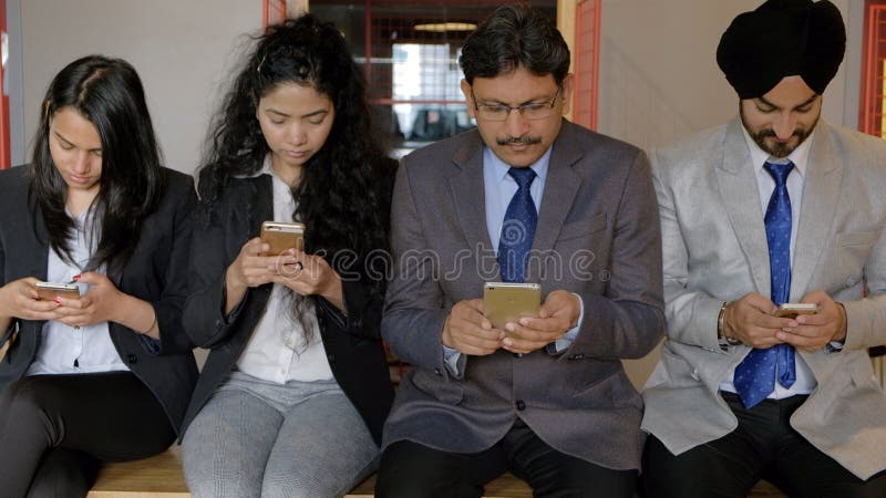 Group of Indian Co-workers on Their Smartphones during the Break Stock ...