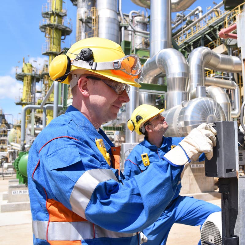 Two Petrochemical Workers Inspecting Pressure Valves on a Fuel Tank ...