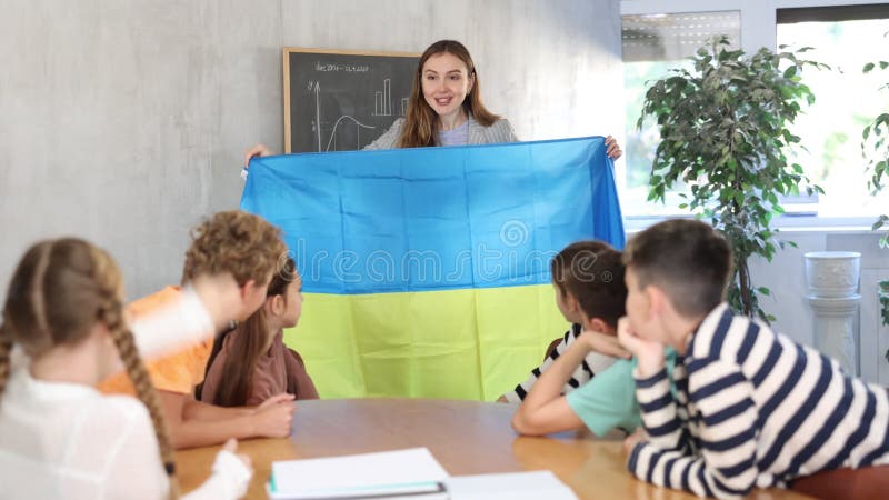 Group of Interested Preteen Learners and Young Female Teacher with Flag ... Group of Interested Preteen Learners and Young Female Teacher with Flag ...