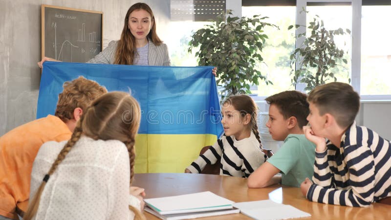 Group of Interested Preteen Learners and Young Female Teacher with Flag ... Group of Interested Preteen Learners and Young Female Teacher with Flag ...