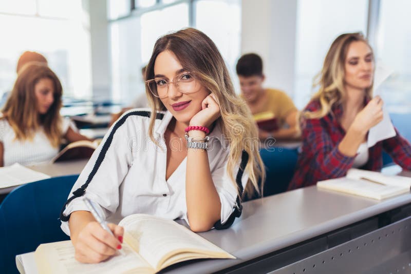 International Students Writing in Lecture Hall and Talking Stock Image ...