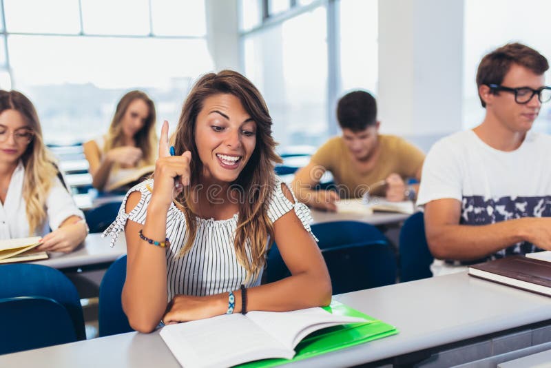 International Students Writing in Lecture Hall and Talking Stock Image ...