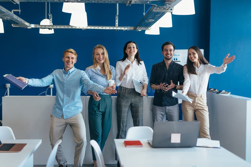 Group of Joyful Young People Welcoming with Open Arms Stock Photo ...