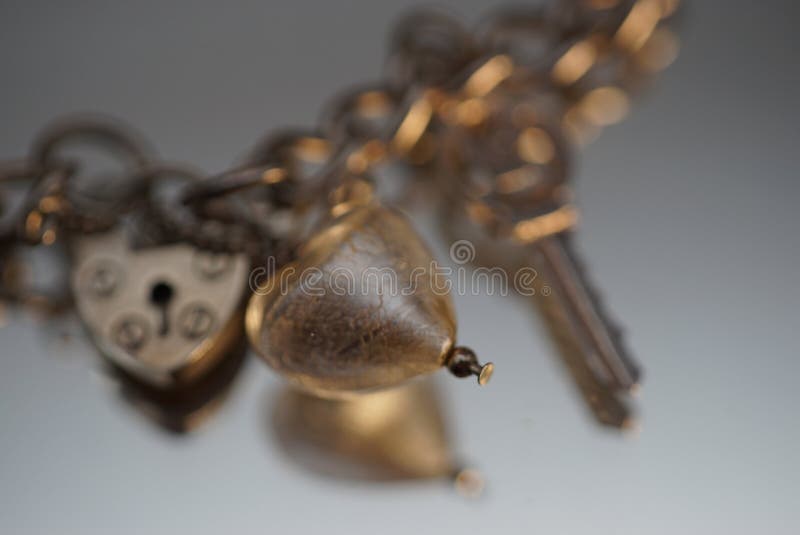 A Group of Keys and a Chain on a Table in Front of a Clock Stock Photo ...