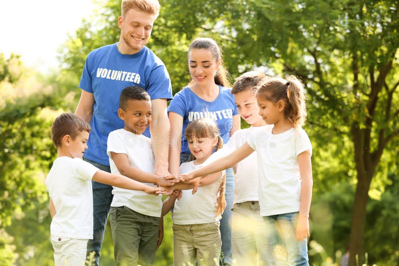 Group of Kids Joining Hands with Volunteers Stock Photo - Image of ...