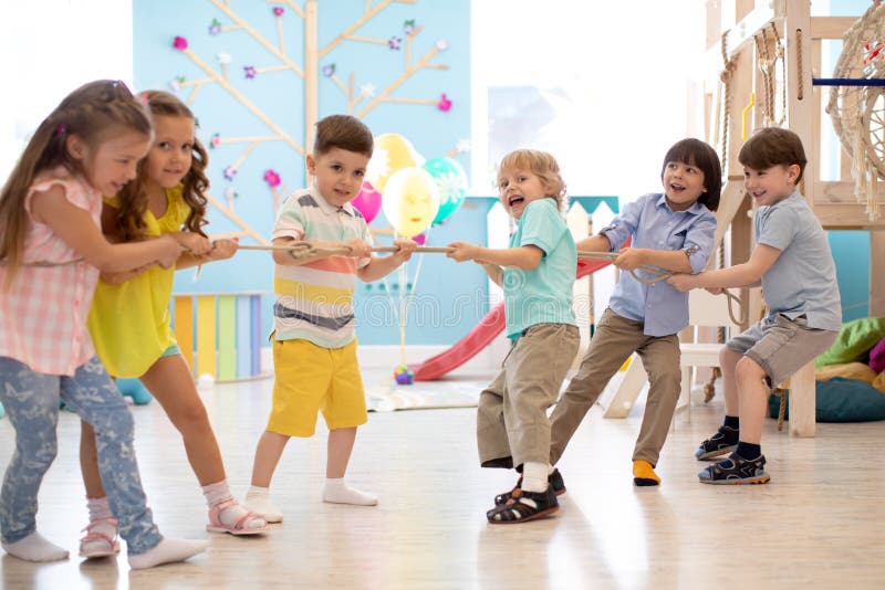 Group of Kids Play and Pull Rope Together in Daycare Stock Photo ... Group of Kids Play and Pull Rope Together in Daycare Stock Photo ...