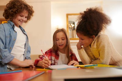 A Group of Kids Preparing Home Work Together and Helping the Classmate ...