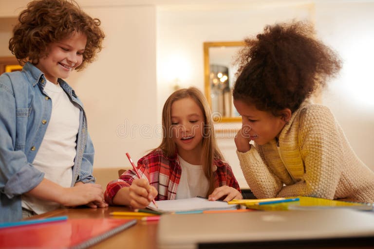 A Group of Kids Preparing Home Work Together and Helping the Classmate ...