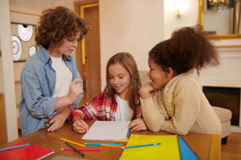 A Group of Kids Preparing Home Work Together and Helping the Classmate ...