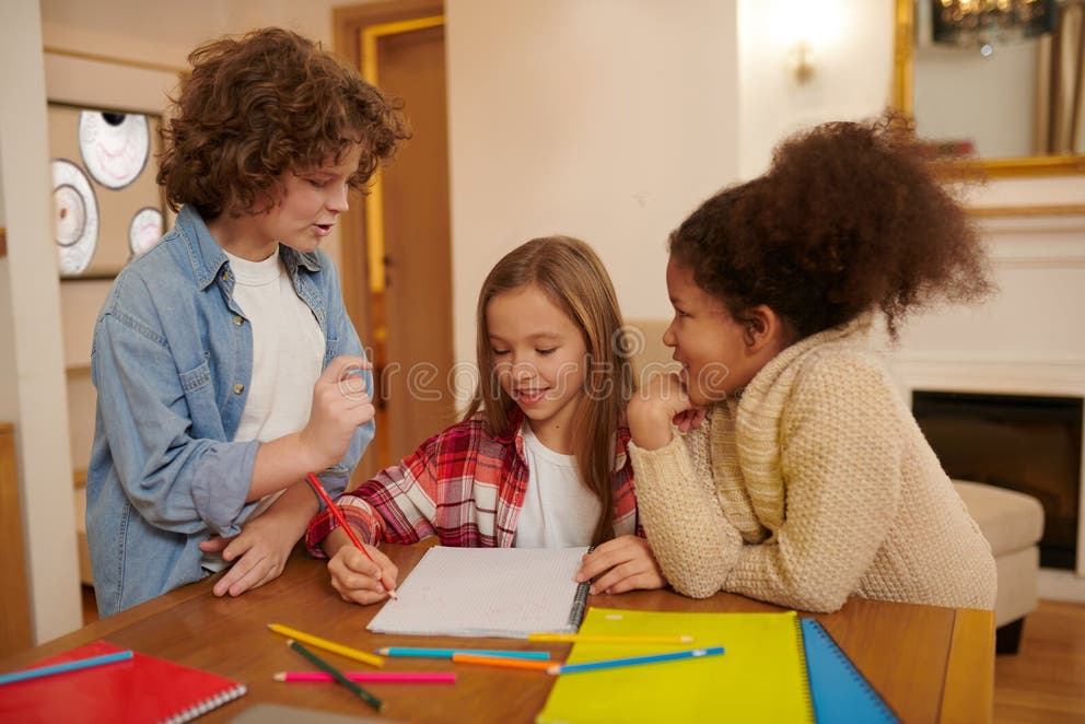 A Group of Kids Preparing Home Work Together and Helping the Classmate ...