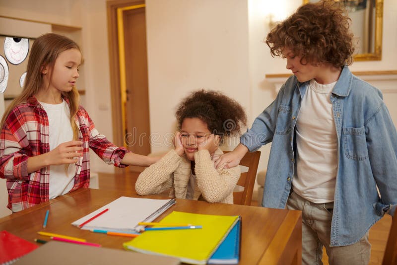 A Group of Kids Preparing Home Work Together and Helping the Classmate ...
