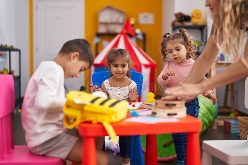 Group of Kids Preschool Students Sitting on Table Drawing on Paper at ...