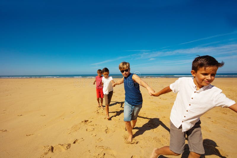 Group of Kids Run, Hold Hands Together on a Beach Stock Photo - Image ...