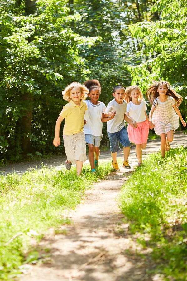 Group of Kids Running Together Over Meadow Stock Image - Image of park ...