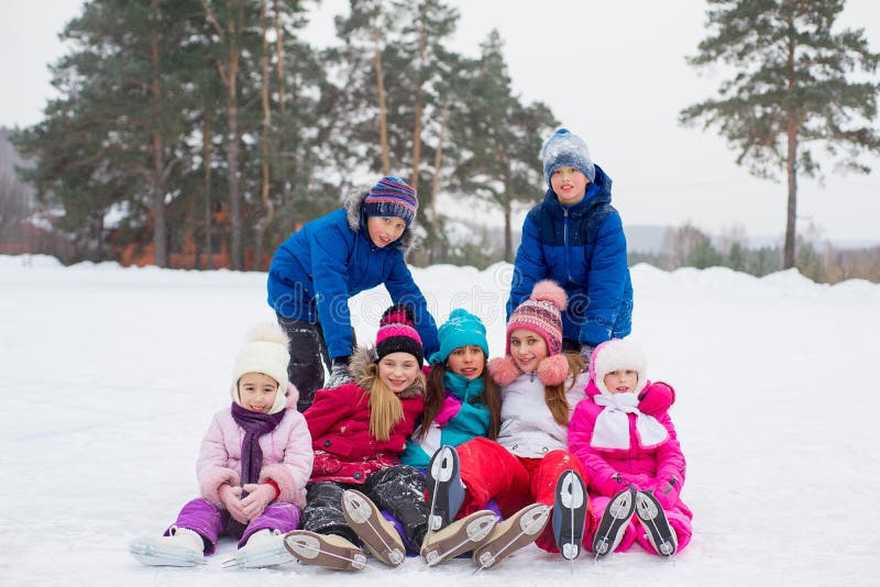 Group of Kids Sitting on the Ice Stock Photo - Image of gloves, holiday ...