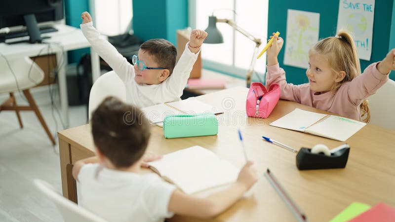 Group of Kids Students Sitting on Table with Winner Expression at ...
