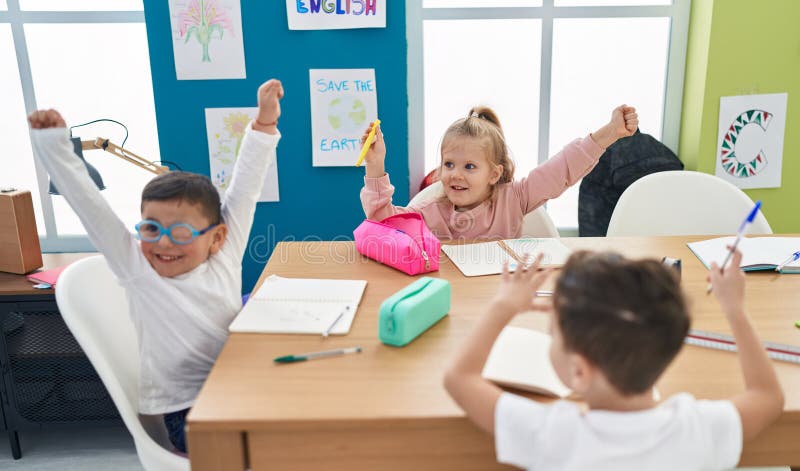 Group of Kids Students Sitting on Table with Winner Expression at ...
