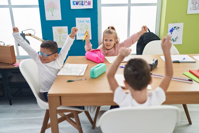 Group of Kids Students Sitting on Table with Winner Expression at ...