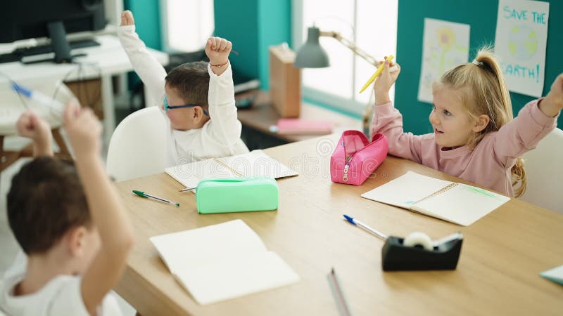 Group of Kids Students Sitting on Table with Winner Expression at ...