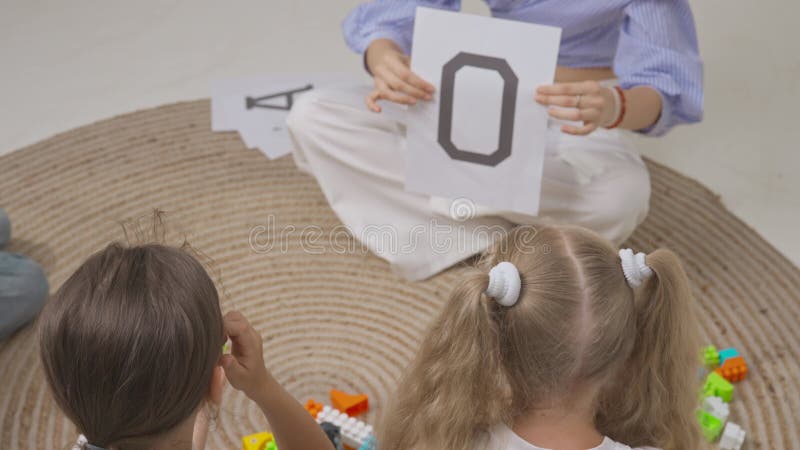 Young Teacher and Group of Children Doing Creative Tasks in ...