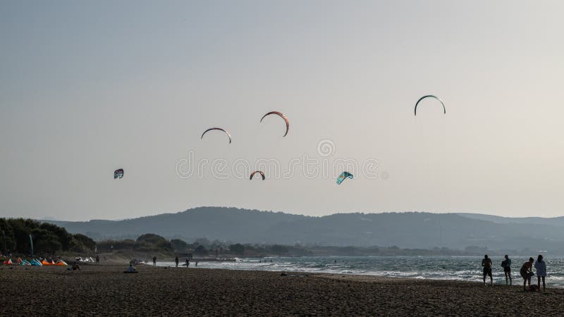 A Group of Kites are Flying in the Sky Above a Beach. the Kites are of ...