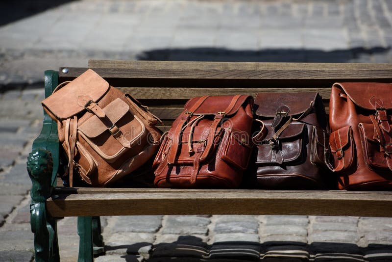 Group of Leather Backpacks on a Wooden Bench Stock Photo - Image of ...